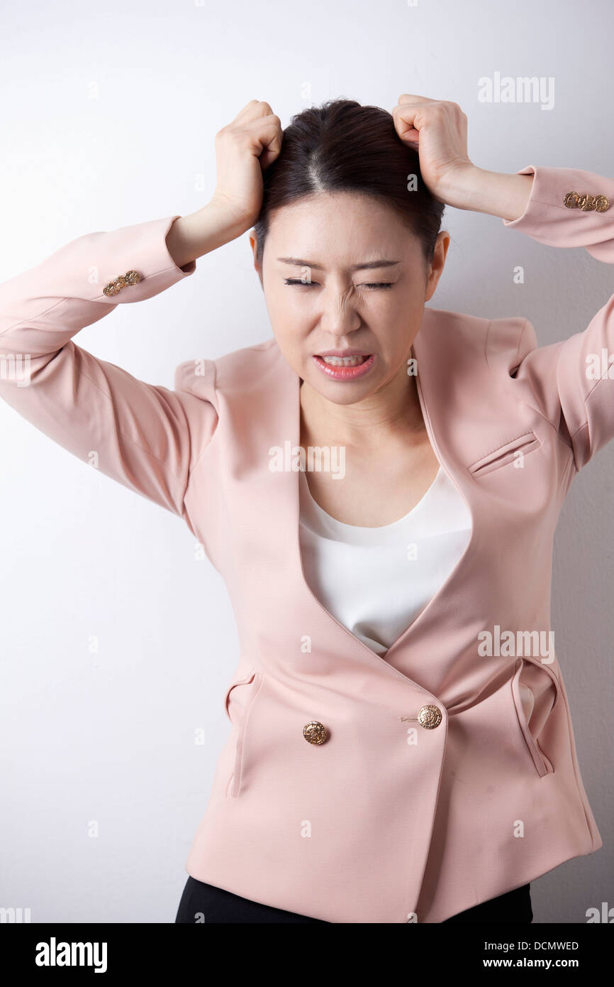 a woman in business suit looking stressed Stock Photo - Alamy