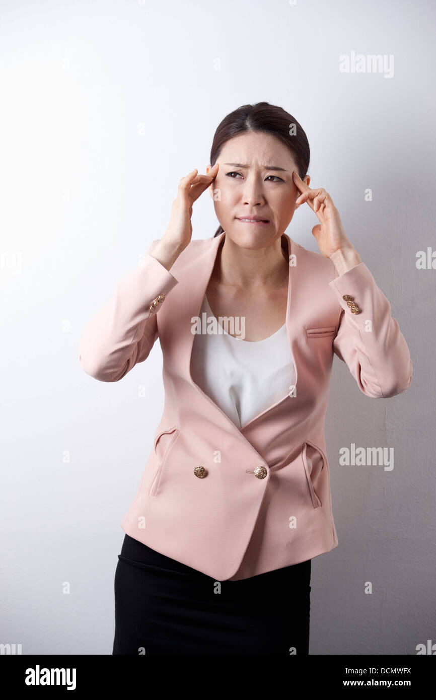 a woman in business suit looking stressed Stock Photo - Alamy