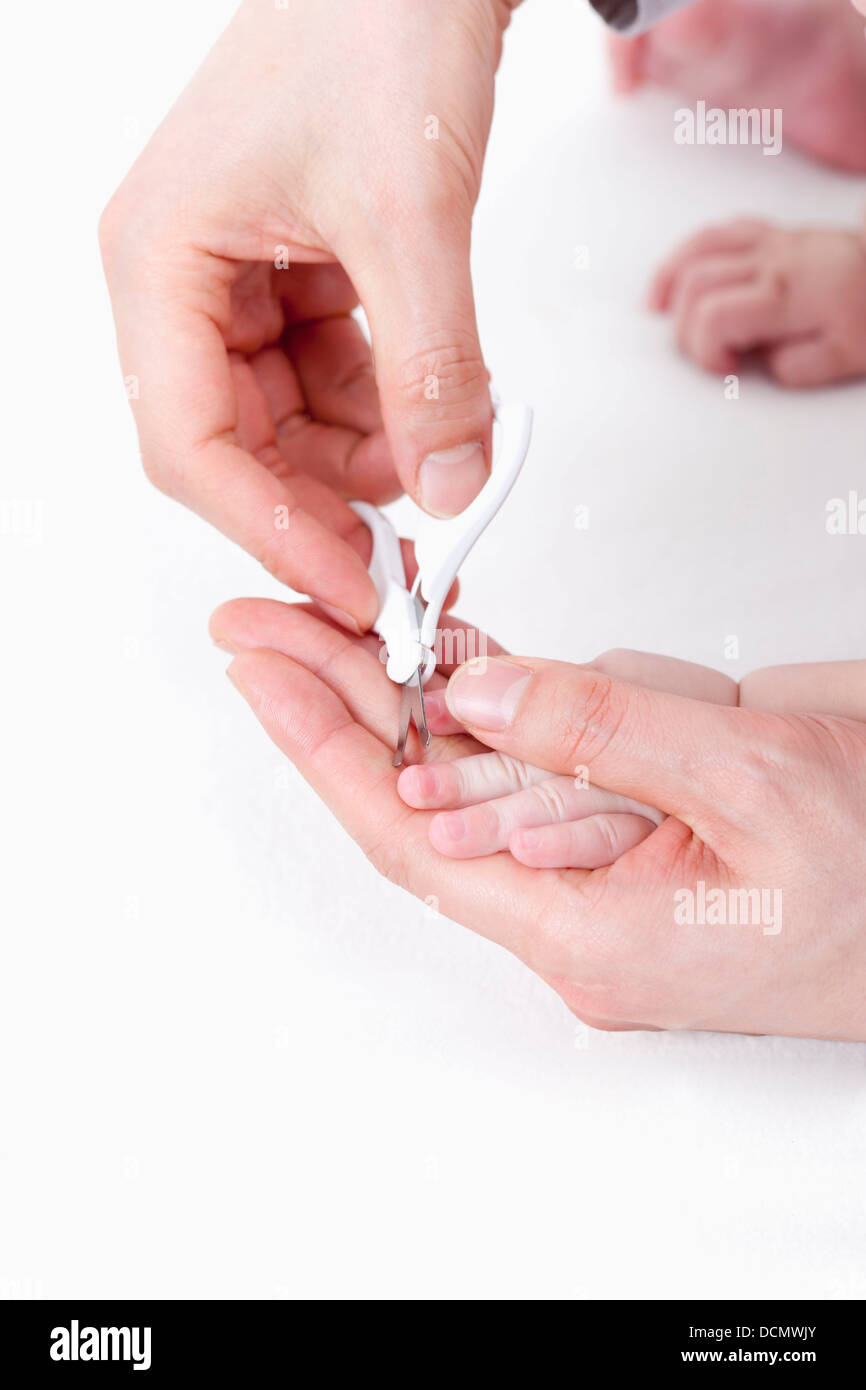 a hand cutting baby's nail Stock Photo - Alamy