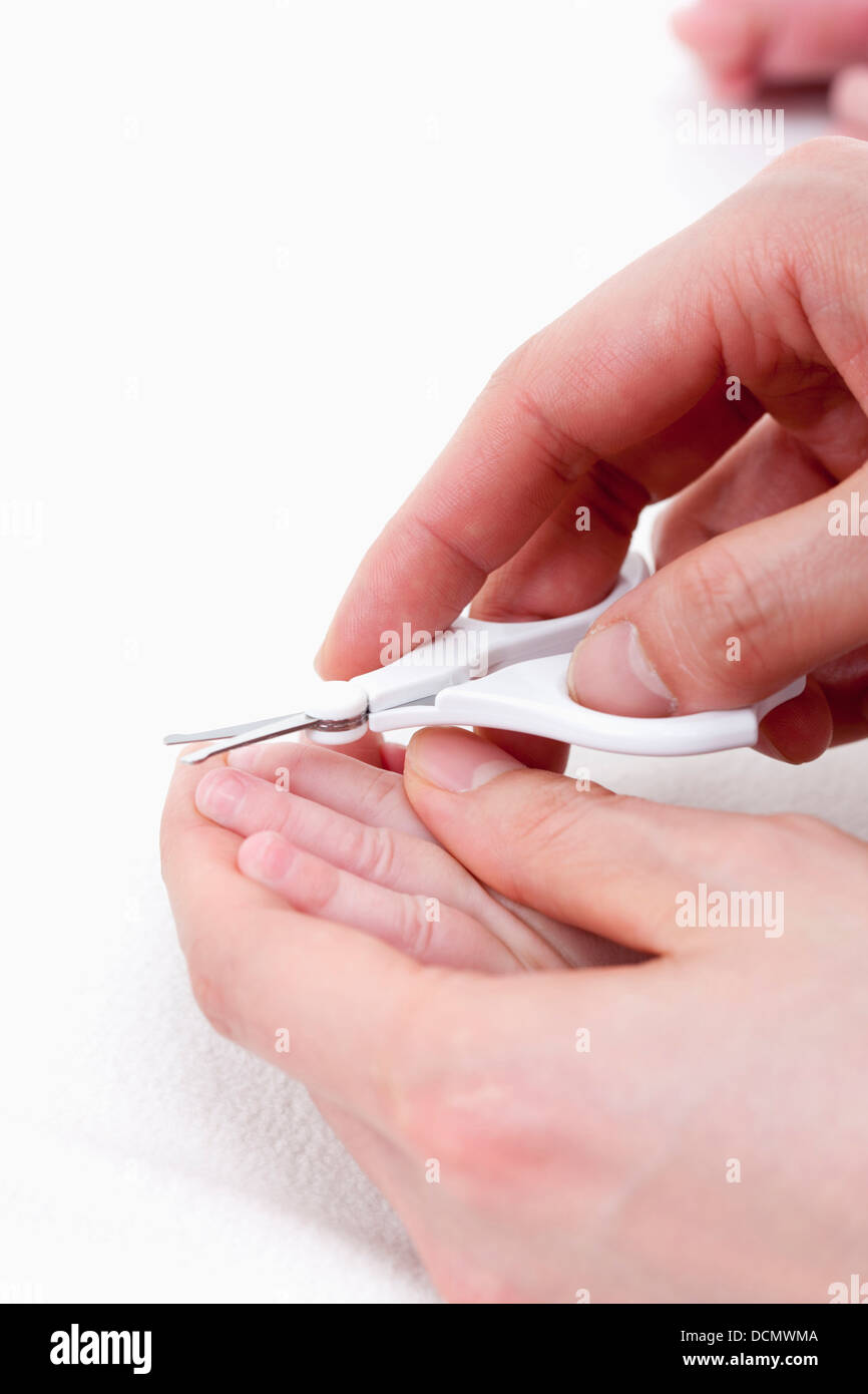 a hand cutting baby's nail Stock Photo - Alamy