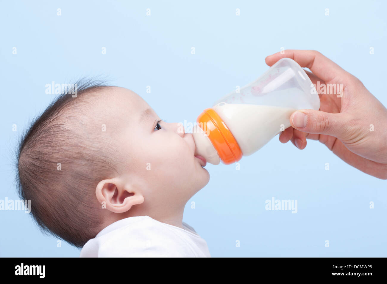 a baby having milk with a bottle Stock Photo - Alamy
