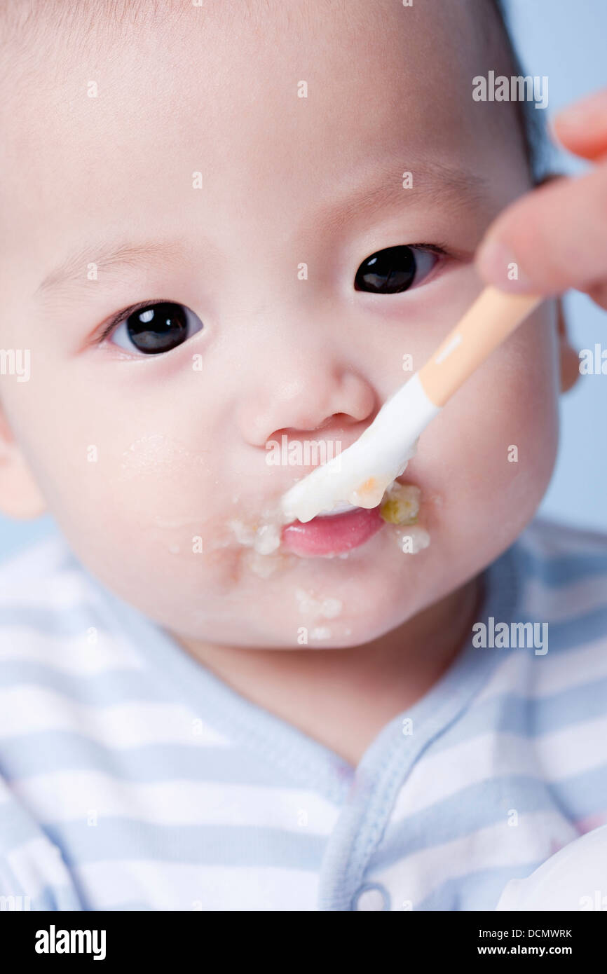 a baby having food Stock Photo - Alamy