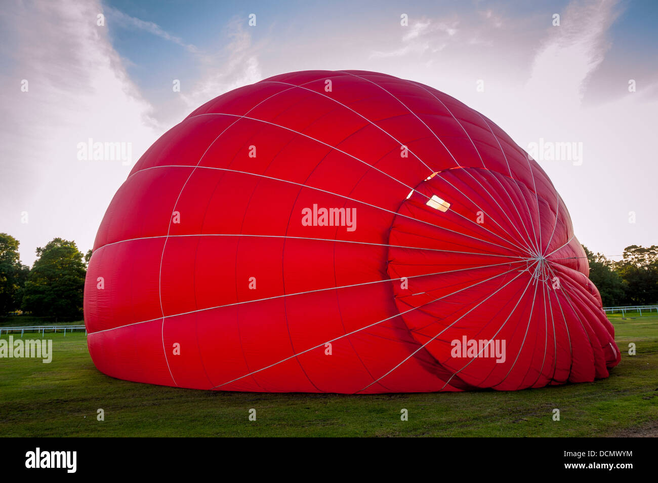 Red Hot air balloon being inflated before take off from York Knavesmire ...