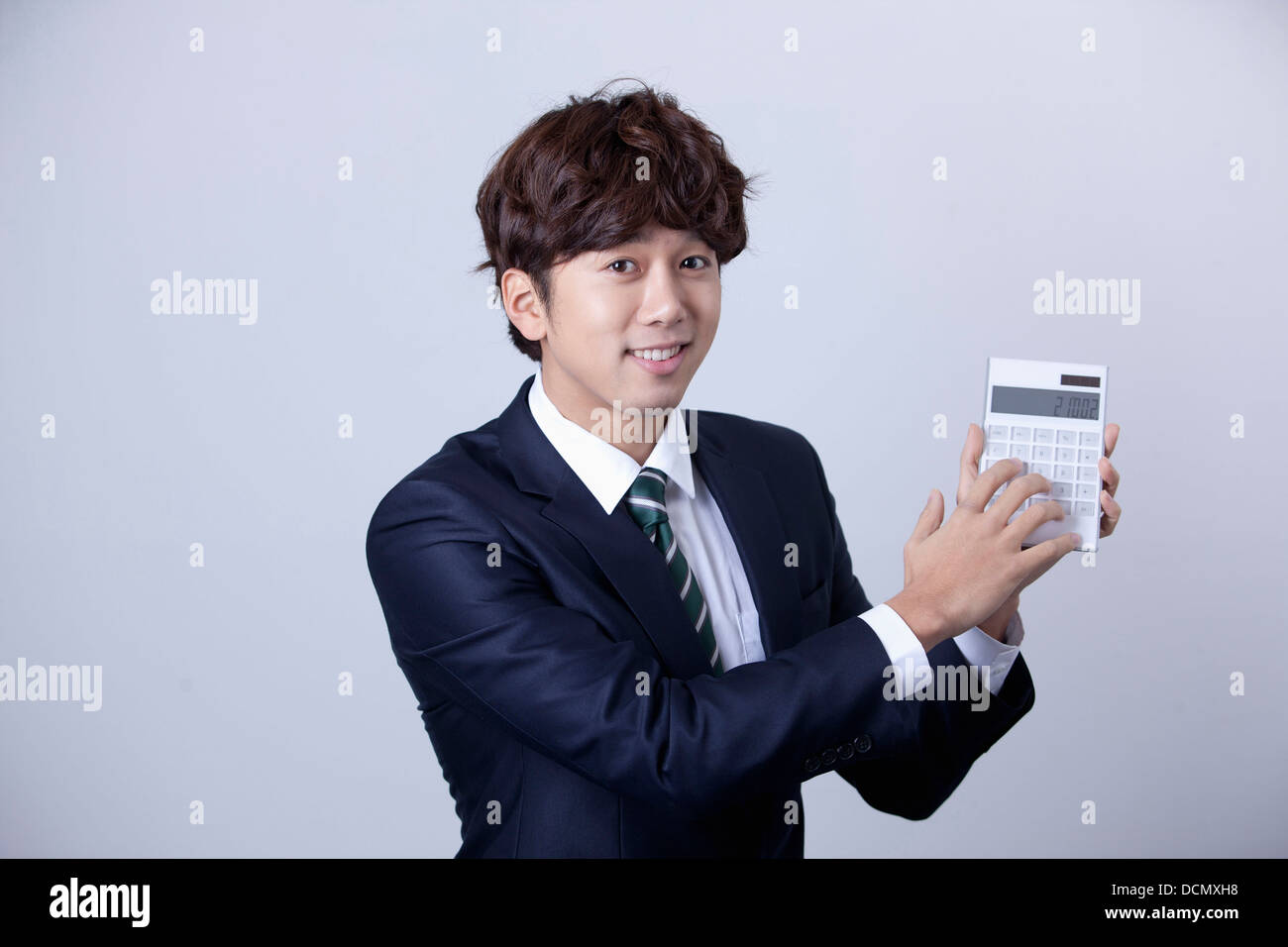 a businessman using a calculator Stock Photo - Alamy