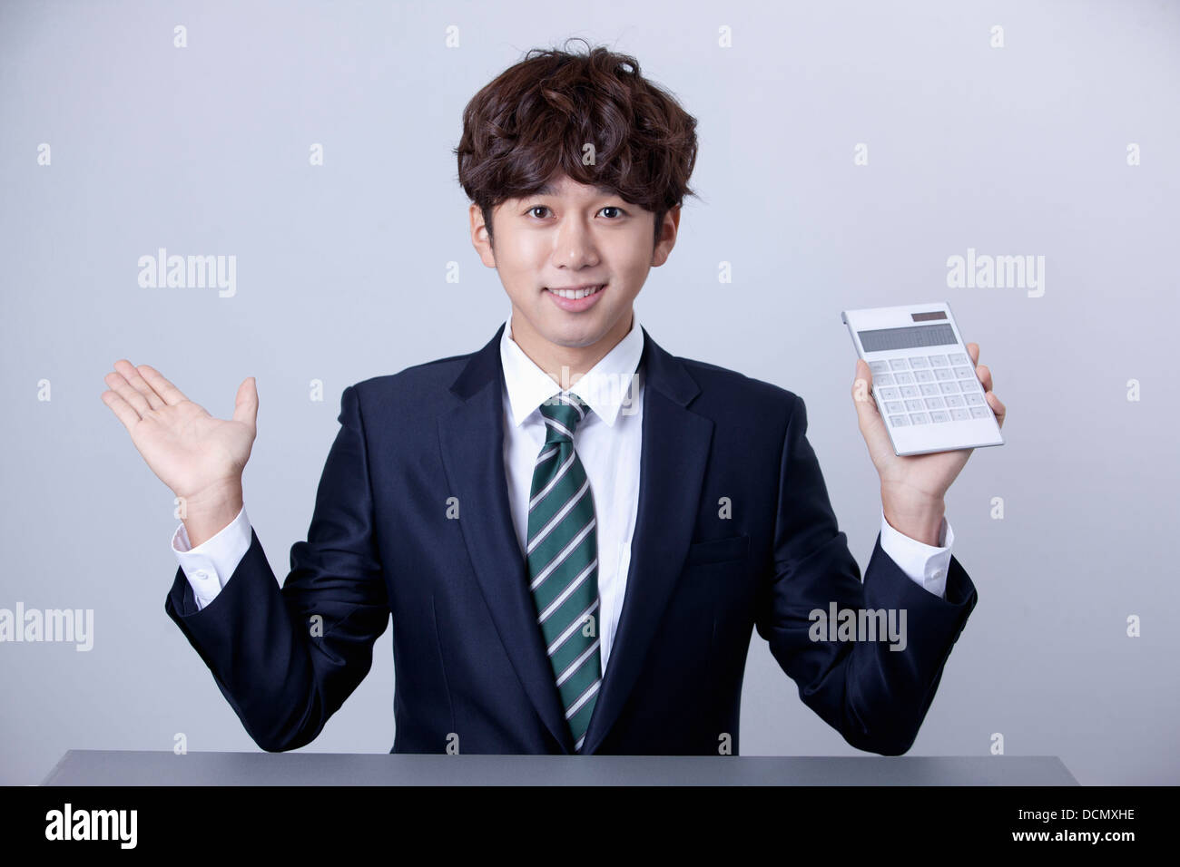 a businessman using a calculator Stock Photo - Alamy