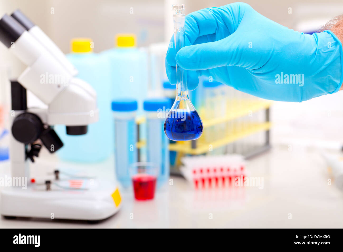 flask with blue liquid in the hand. Science lab research Stock Photo ...