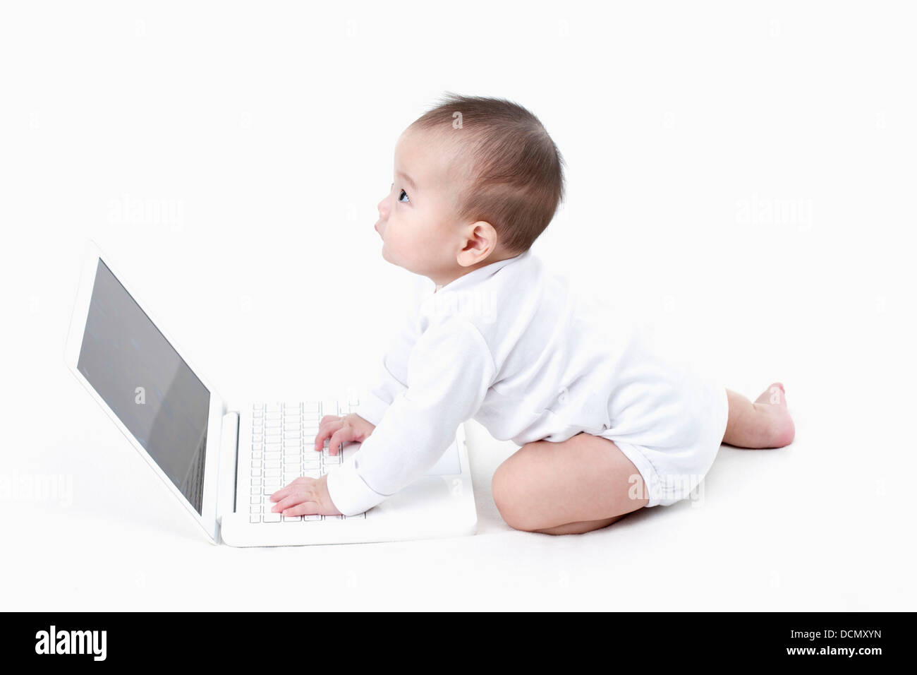 a baby playing with a laptop Stock Photo - Alamy
