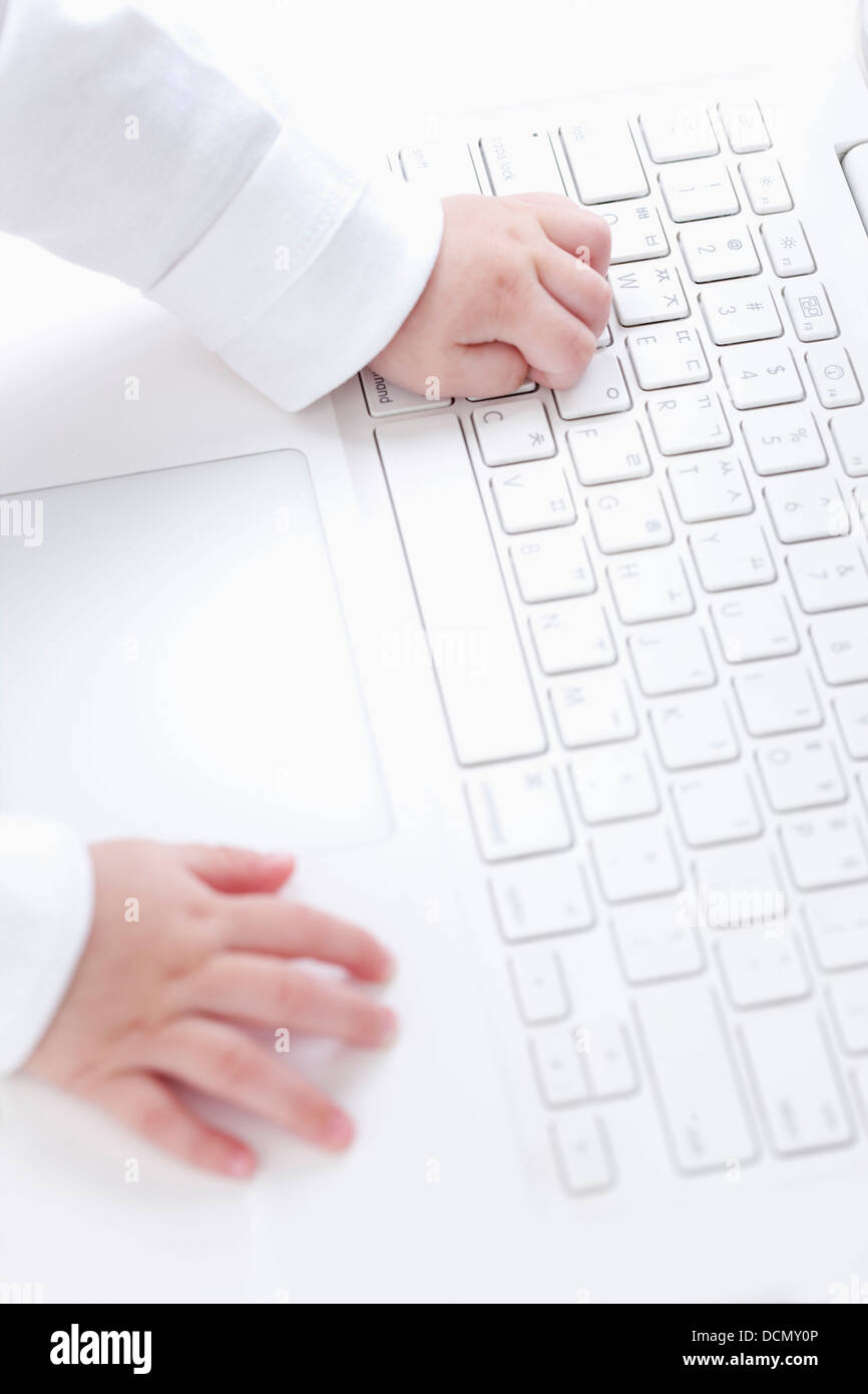 Baby touching laptop keyboard hi-res stock photography and images - Alamy