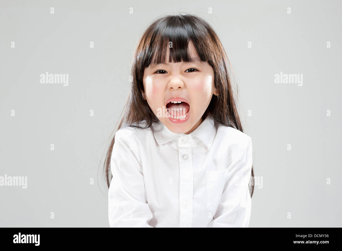 a girl in white shirt shouting Stock Photo - Alamy