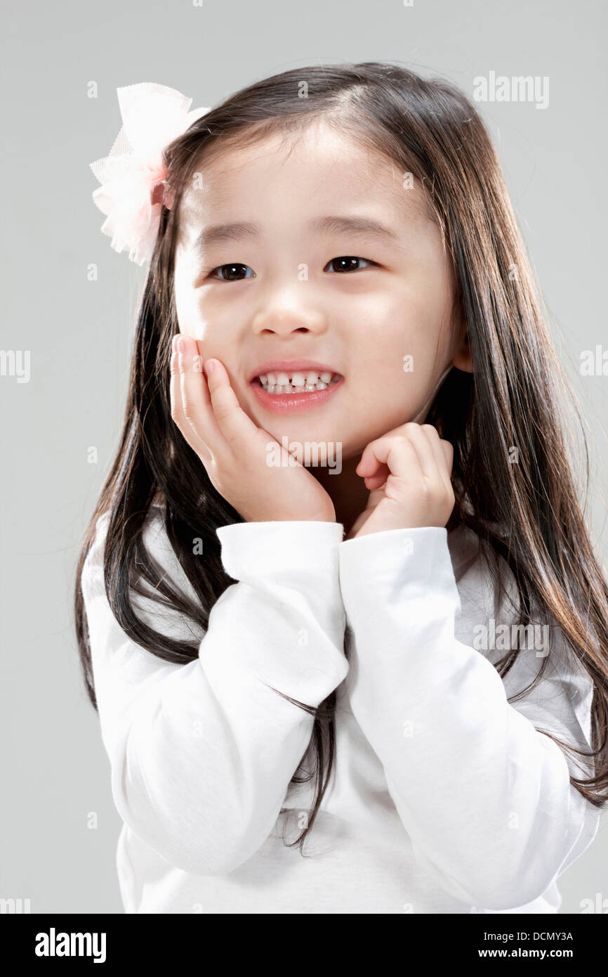 a girl in white shirt smiling Stock Photo - Alamy