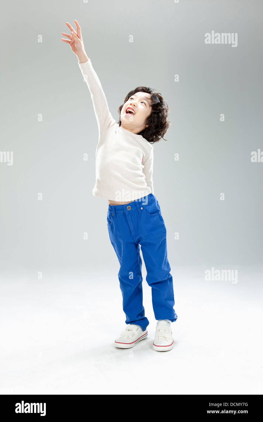 a boy jumping to reach something Stock Photo - Alamy