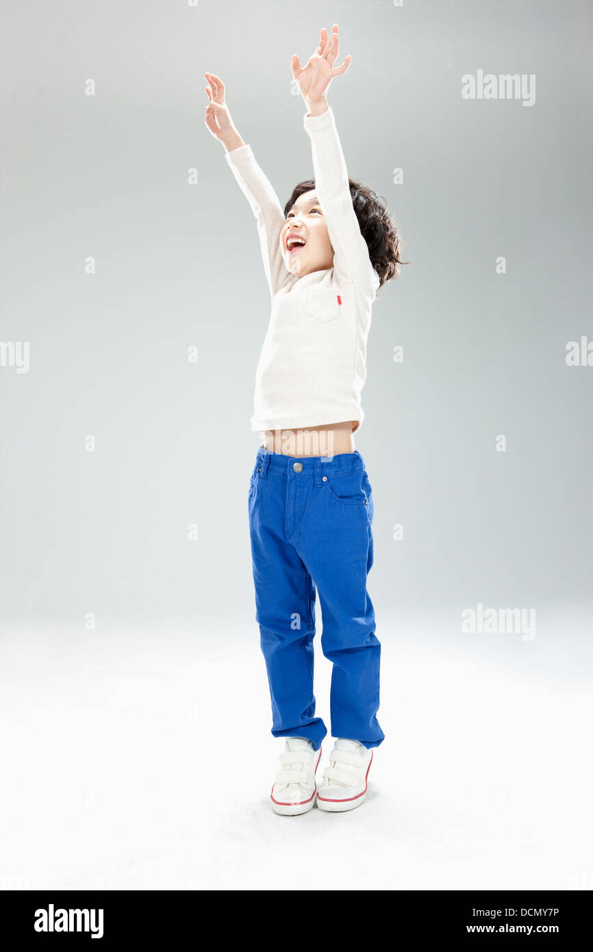 a boy jumping to reach something Stock Photo - Alamy