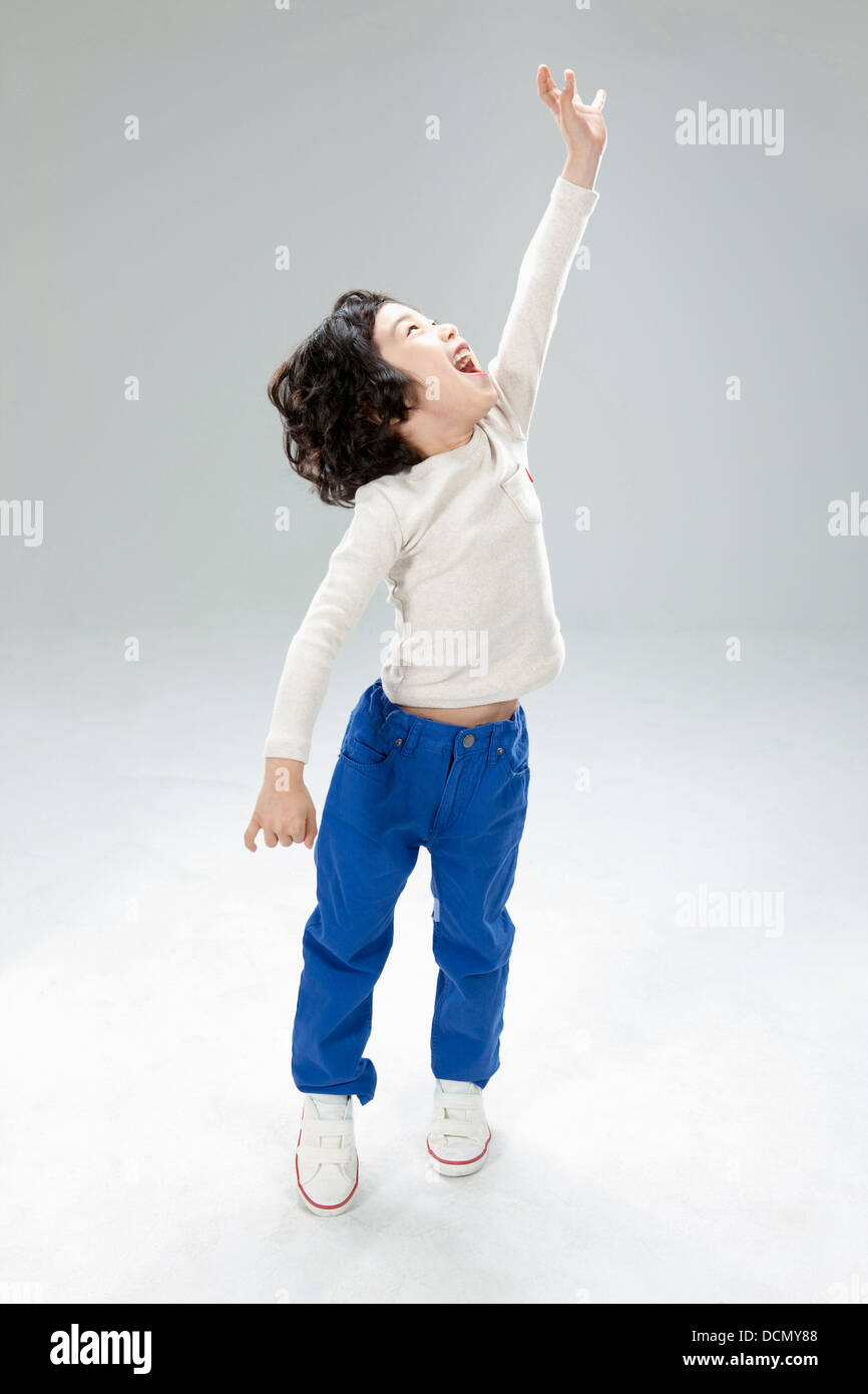 a boy jumping to reach something Stock Photo - Alamy