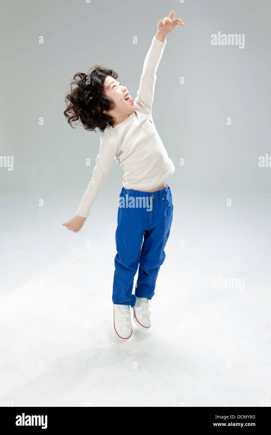 a boy jumping to reach something Stock Photo - Alamy