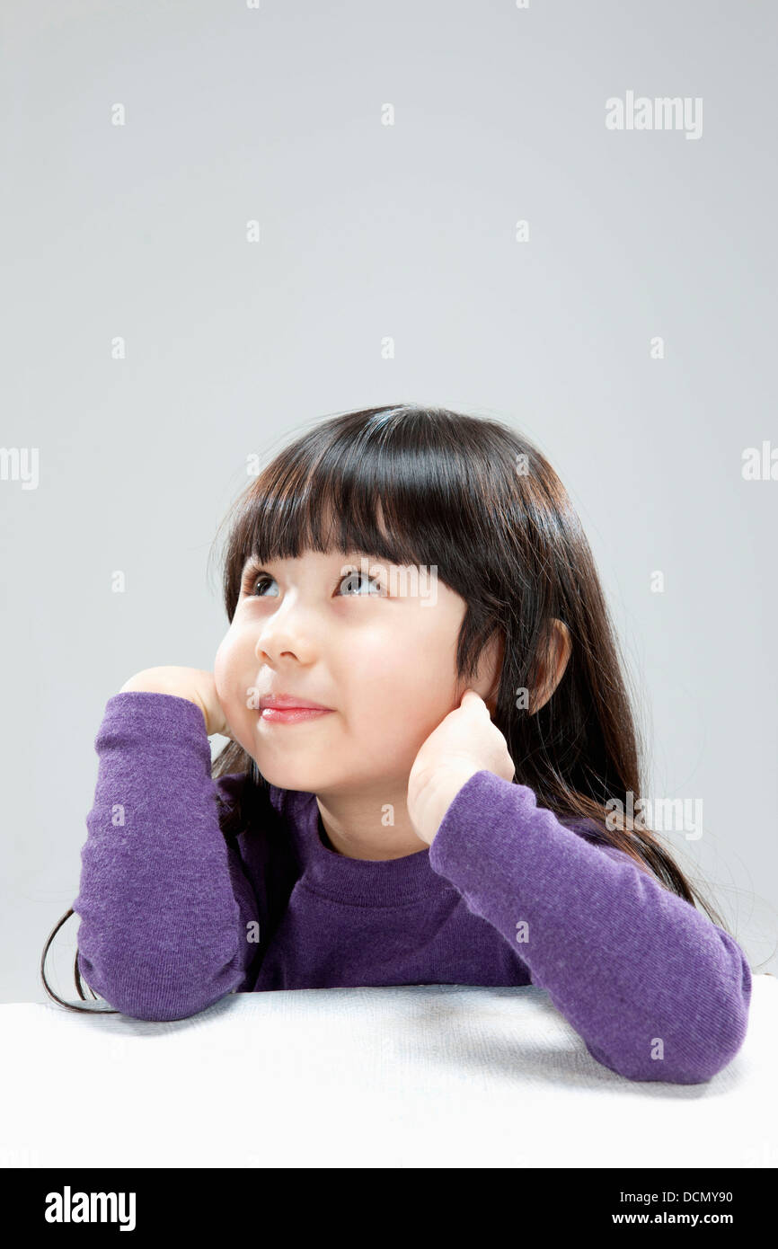 a girl leaning on a chair Stock Photo - Alamy