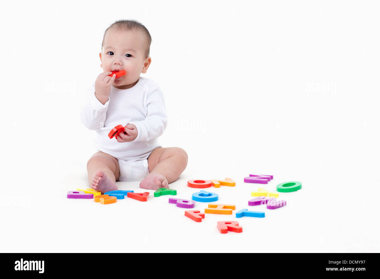 a baby playing with alphabet blocks Stock Photo - Alamy