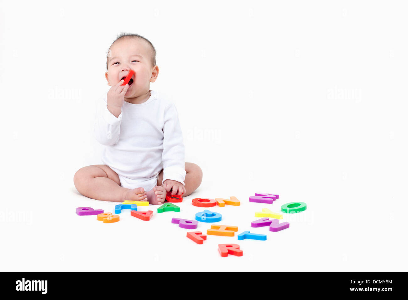 a baby playing with alphabet blocks Stock Photo - Alamy