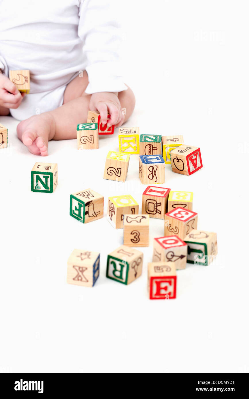 a baby playing with blocks Stock Photo - Alamy