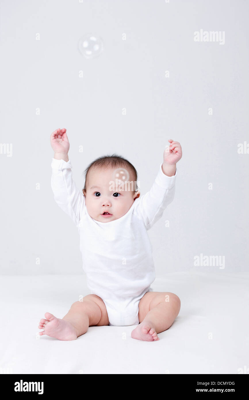 a baby and bubbles in the air Stock Photo - Alamy