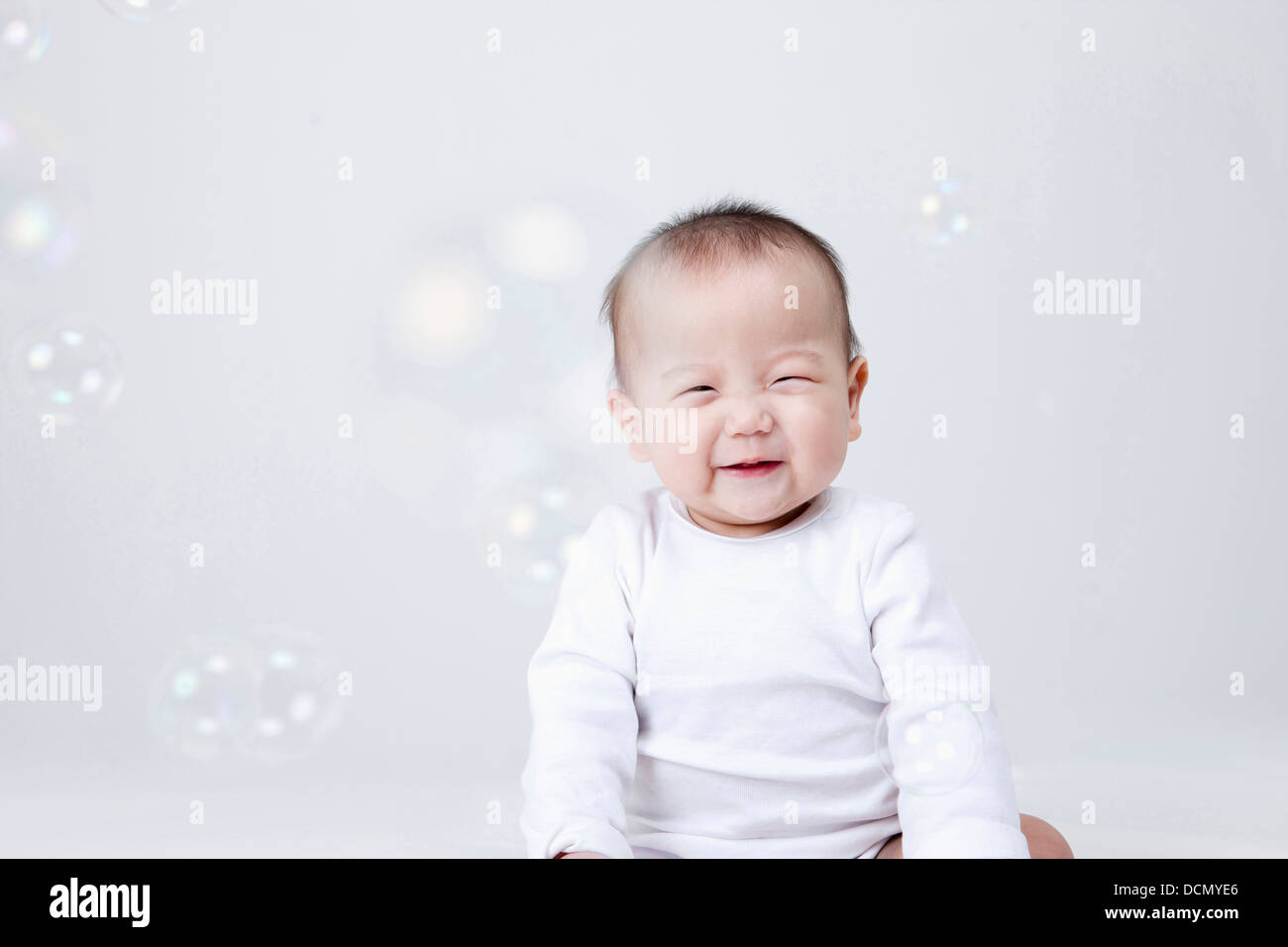 a baby and bubbles in the air Stock Photo - Alamy