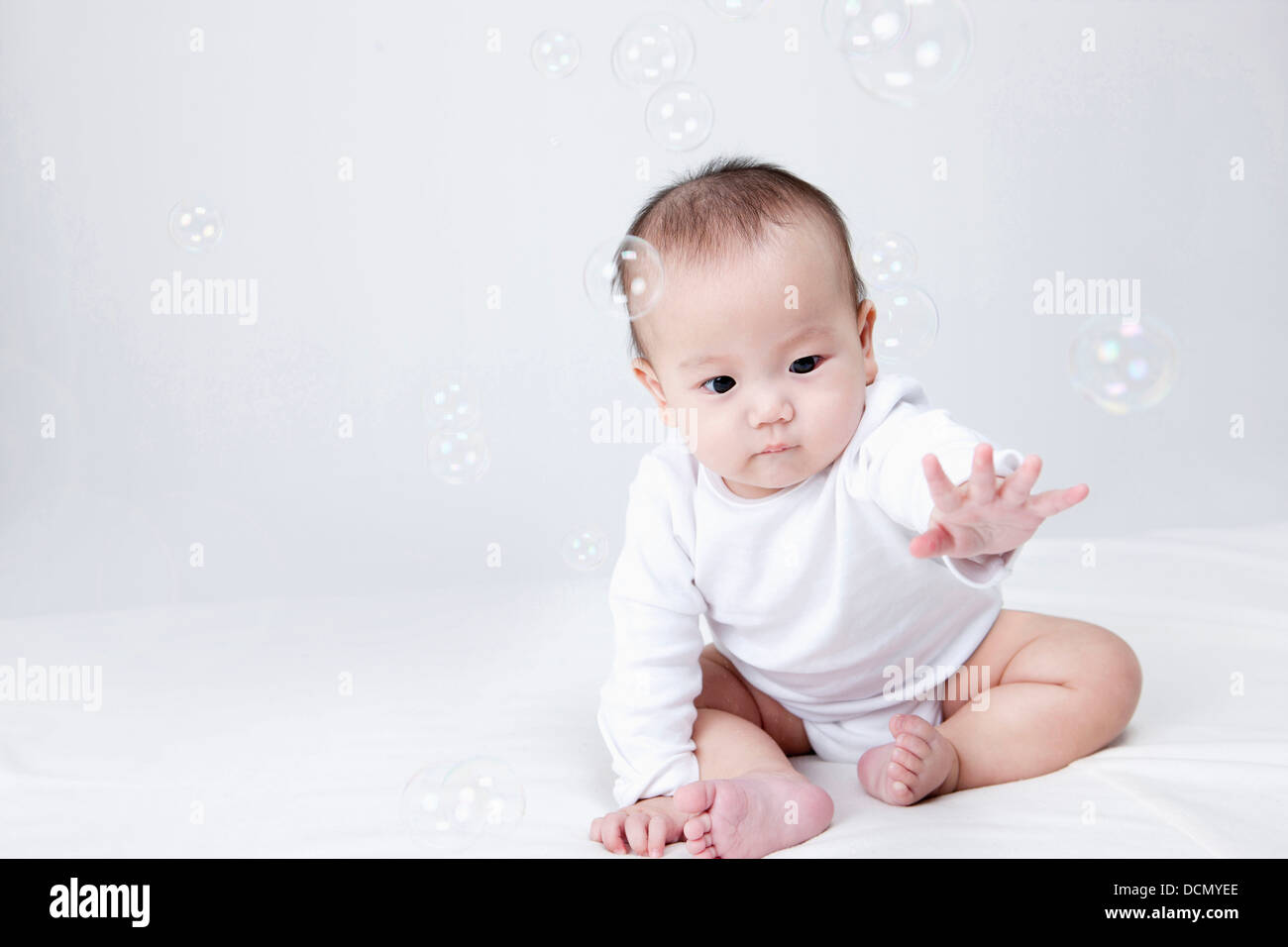 a baby and bubbles in the air Stock Photo - Alamy