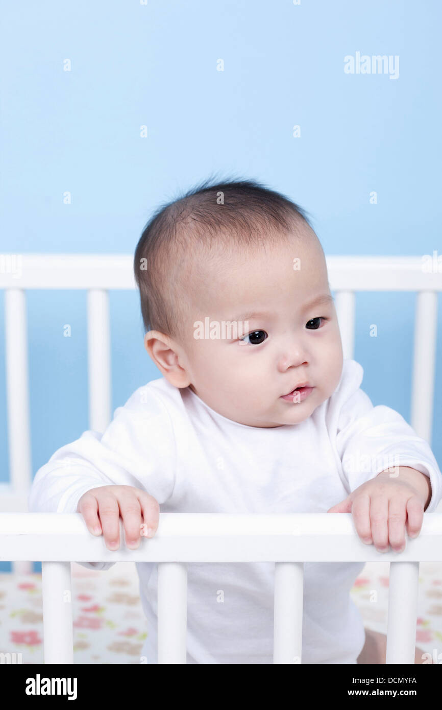 a baby inside a crib Stock Photo - Alamy