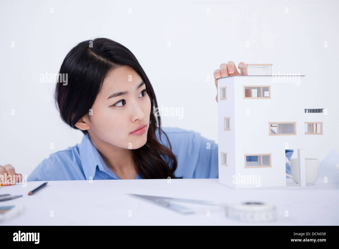 an interior designer with a model house Stock Photo - Alamy