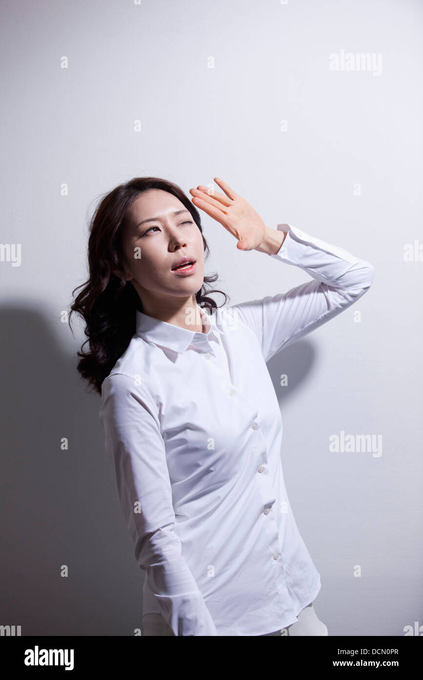 a woman in white shirt avoiding sun light Stock Photo - Alamy