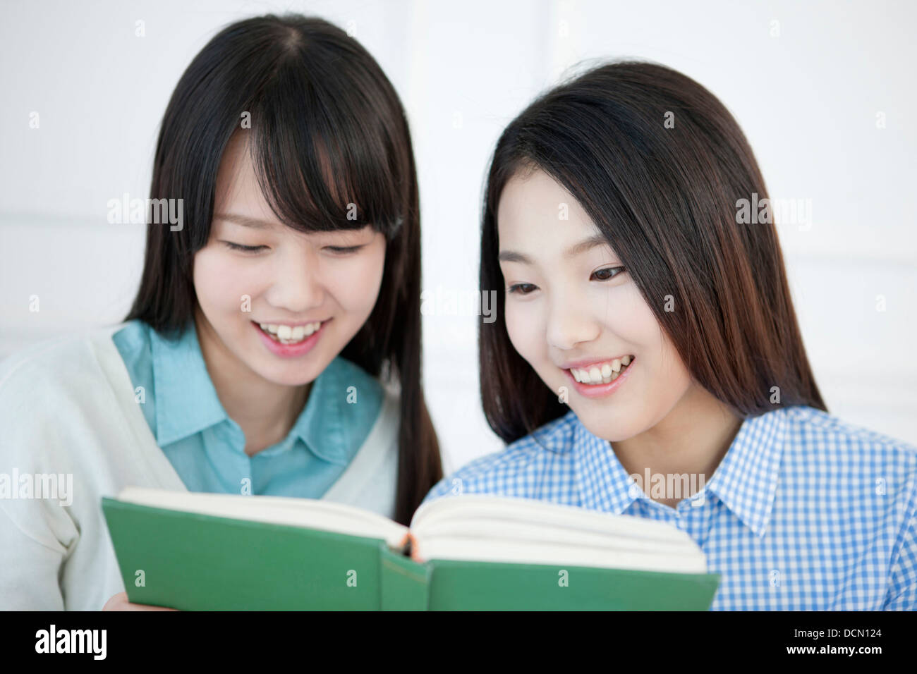 two ladies reading a book together Stock Photo - Alamy