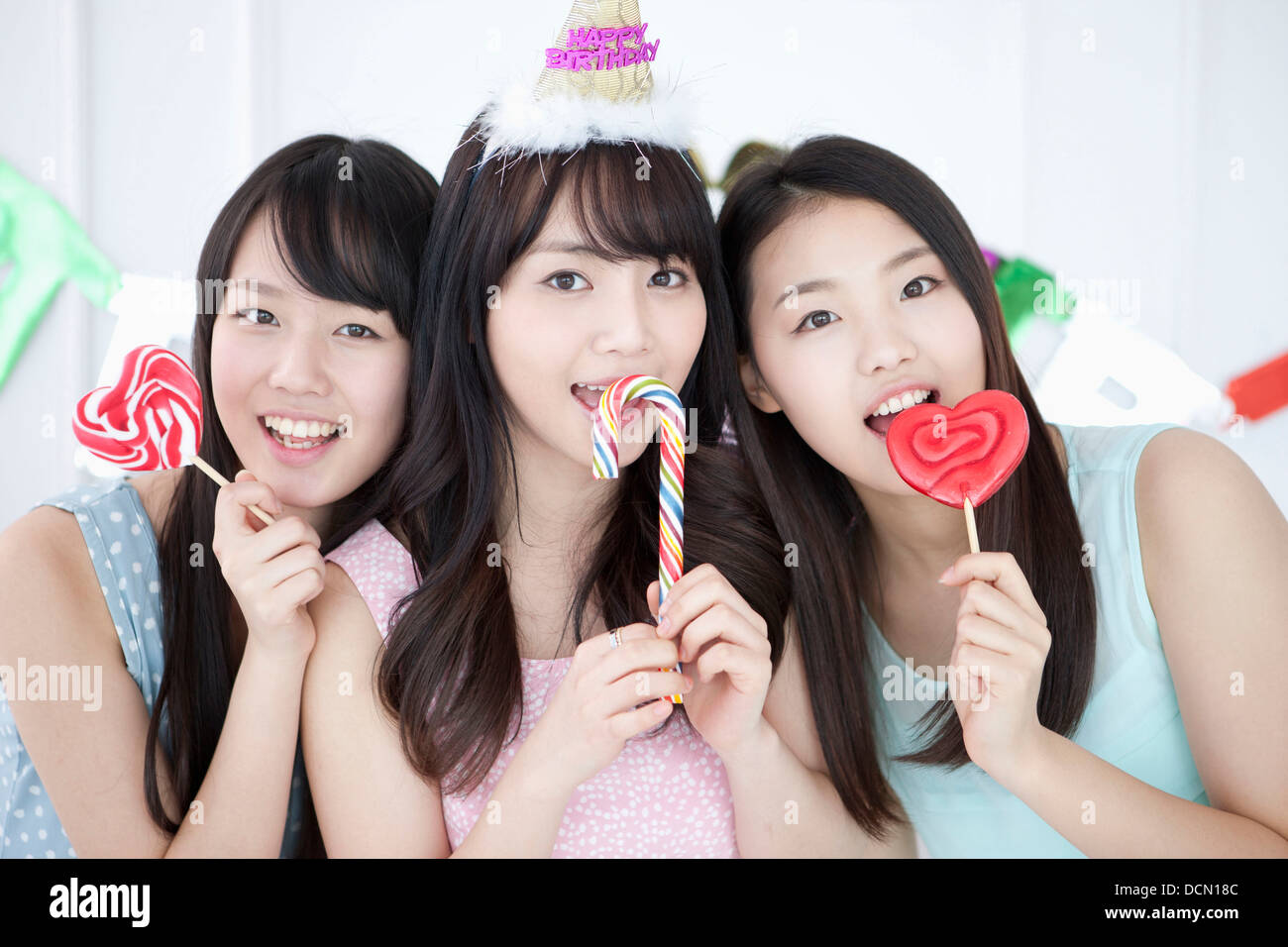 ladies posing with lollipops in the party Stock Photo - Alamy