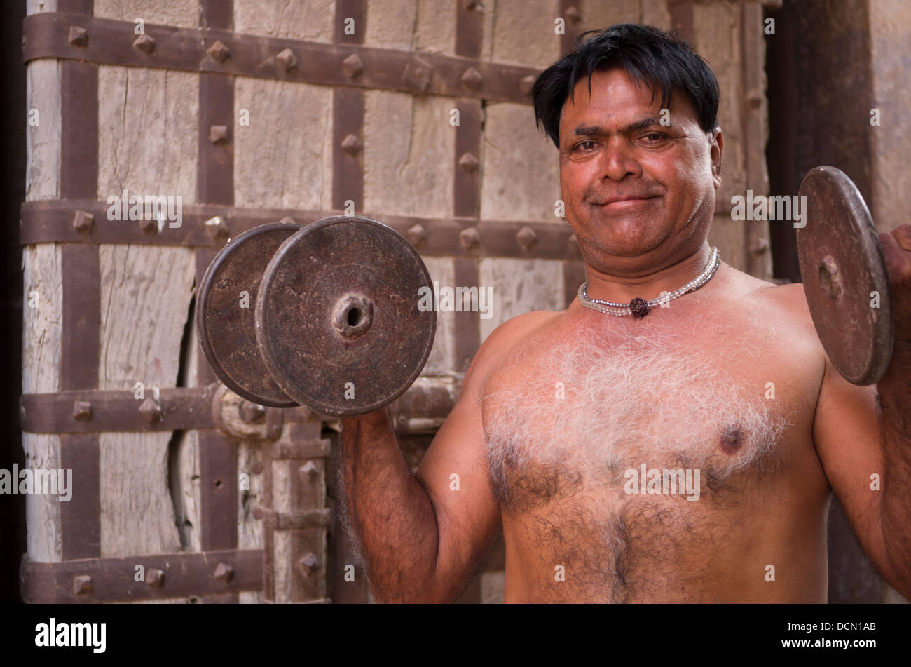 Indian man training with dumbells outside the gates of Meherangarh Fort ...