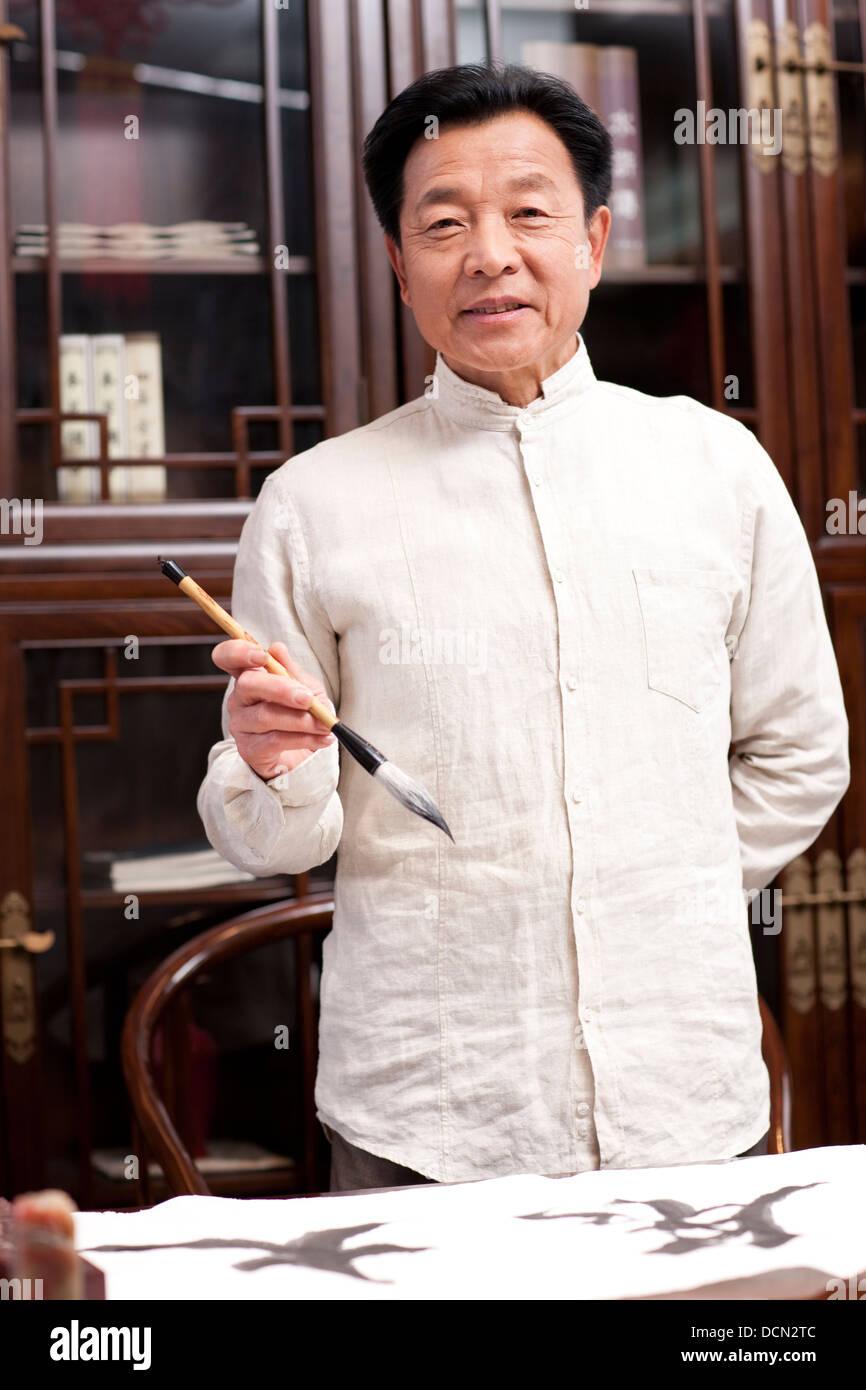 Senior man practicing calligraphy in the study Stock Photo - Alamy