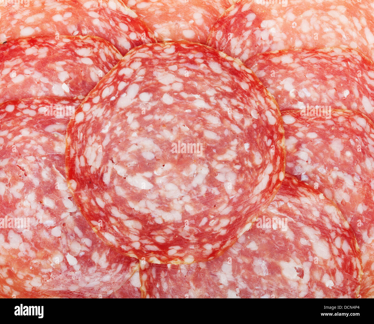 Sliced salami detail texture background Stock Photo - Alamy
