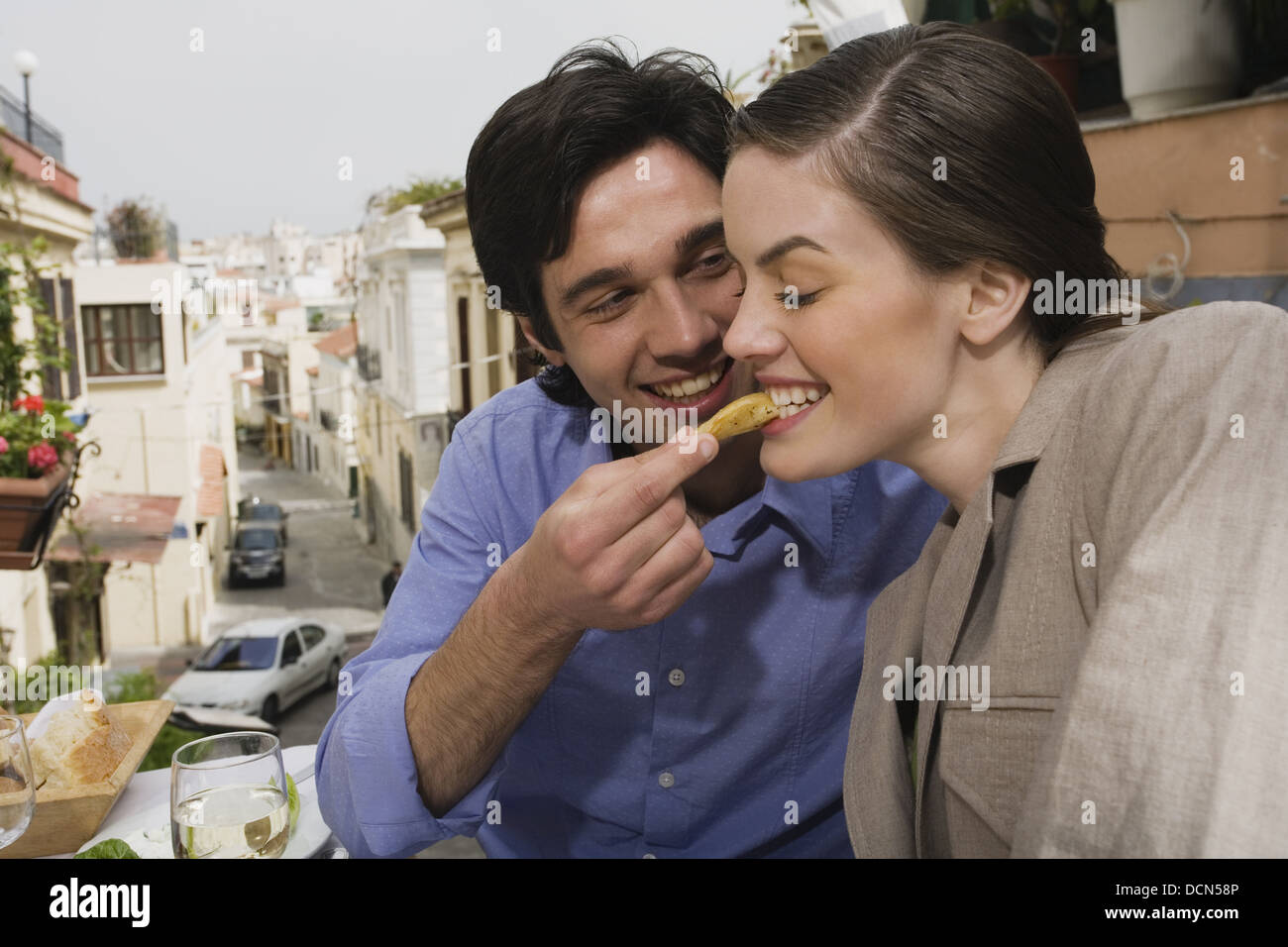 Man feeding woman at restaurant Stock Photo - Alamy