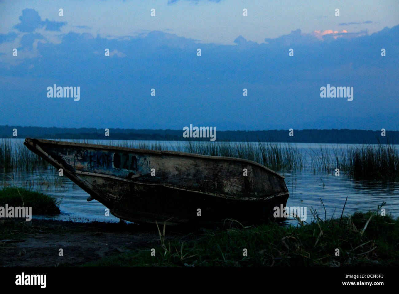 Landscape photograph of boat on shores of Lake Victoria at sunrise ...