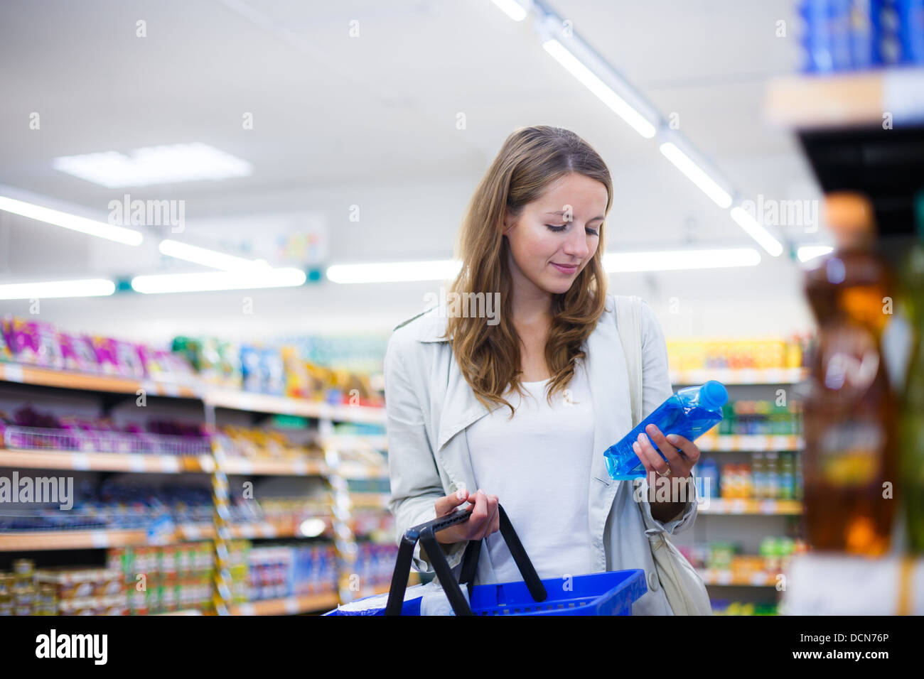 Beautiful young woman shopping in a grocery store/supermarket Stock Photo - Alamy