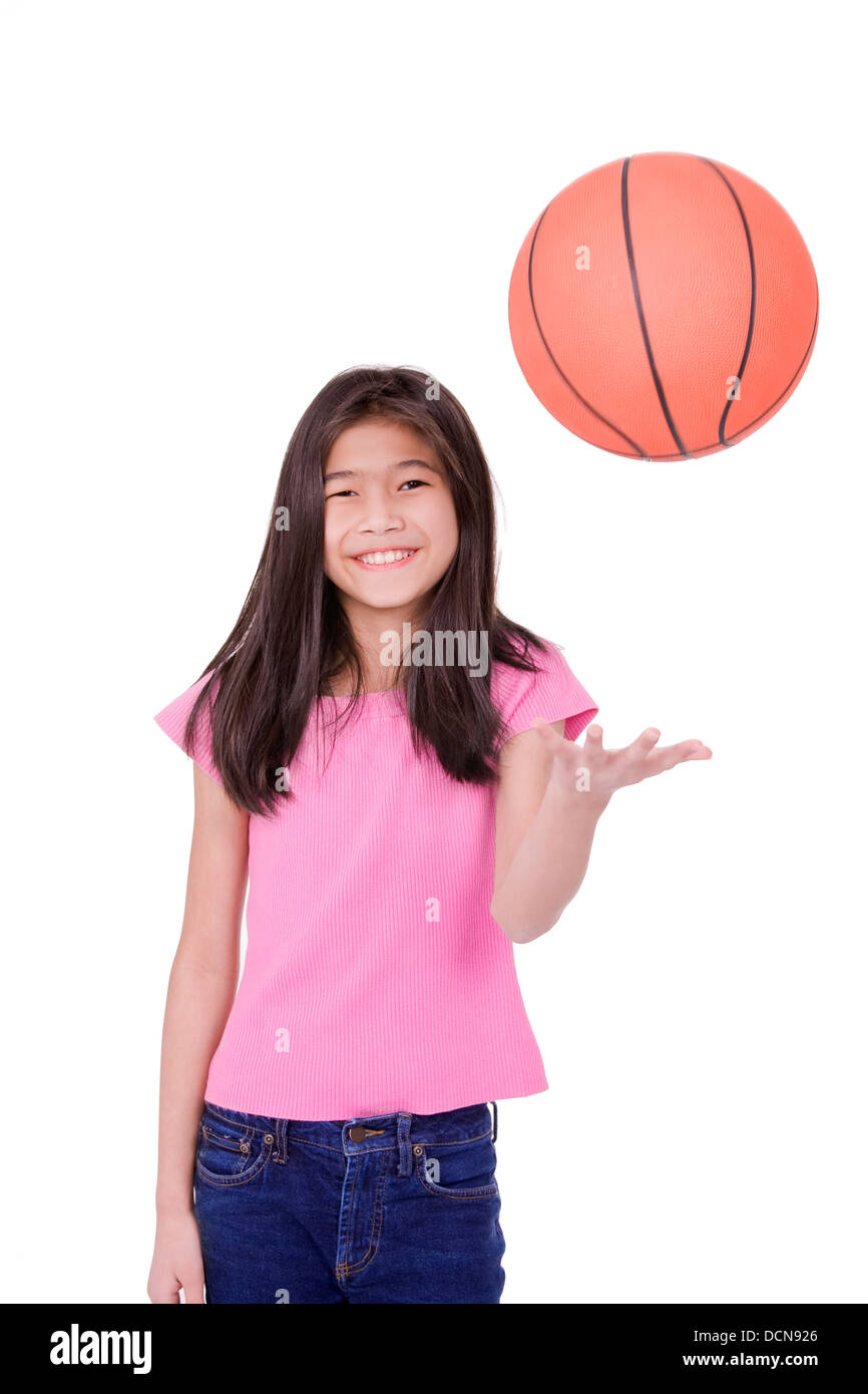 Young girl throwing basketball, isolated on white Stock Photo - Alamy