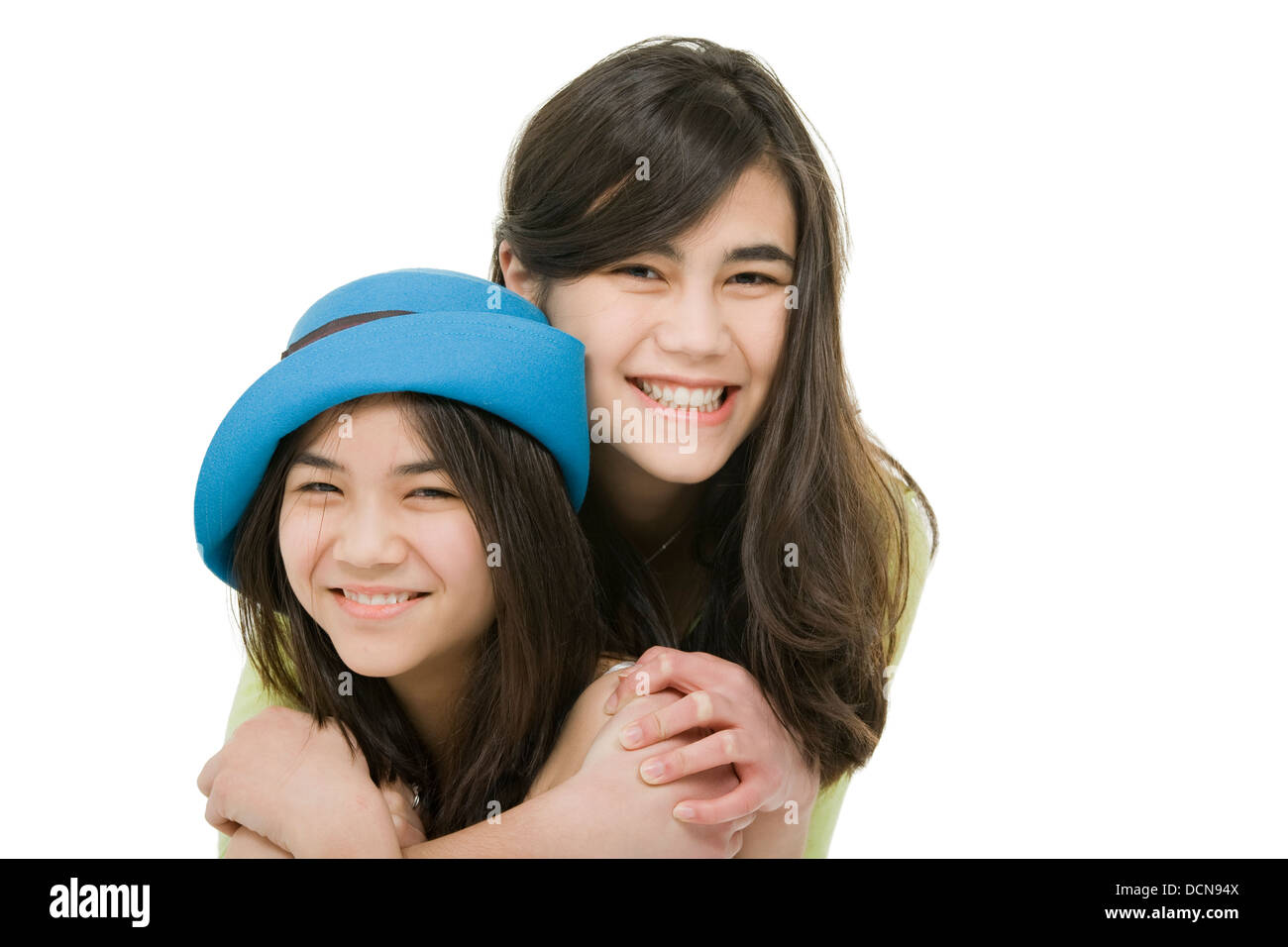 Two sisters together, isolated on white Stock Photo - Alamy