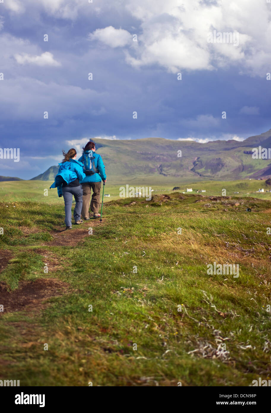 Hikers walking near the Trotternish Ridge on the Isle of Skye, Scotland ...