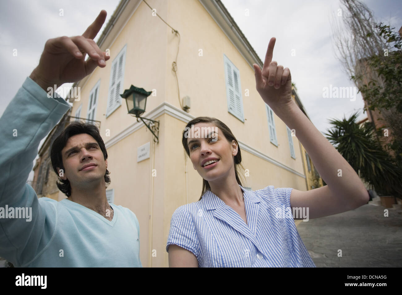 Man and woman pointing Stock Photo - Alamy