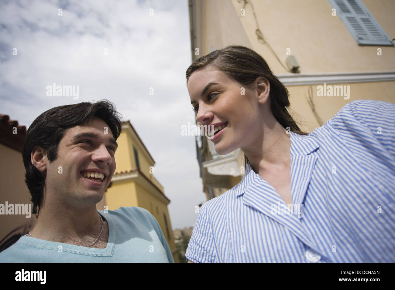 Man and woman smiling at each other Stock Photo - Alamy