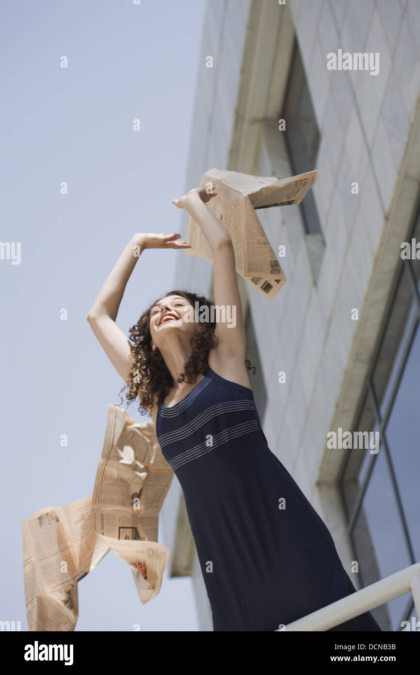 Happy businesswoman throwing newspaper in the air Stock Photo - Alamy