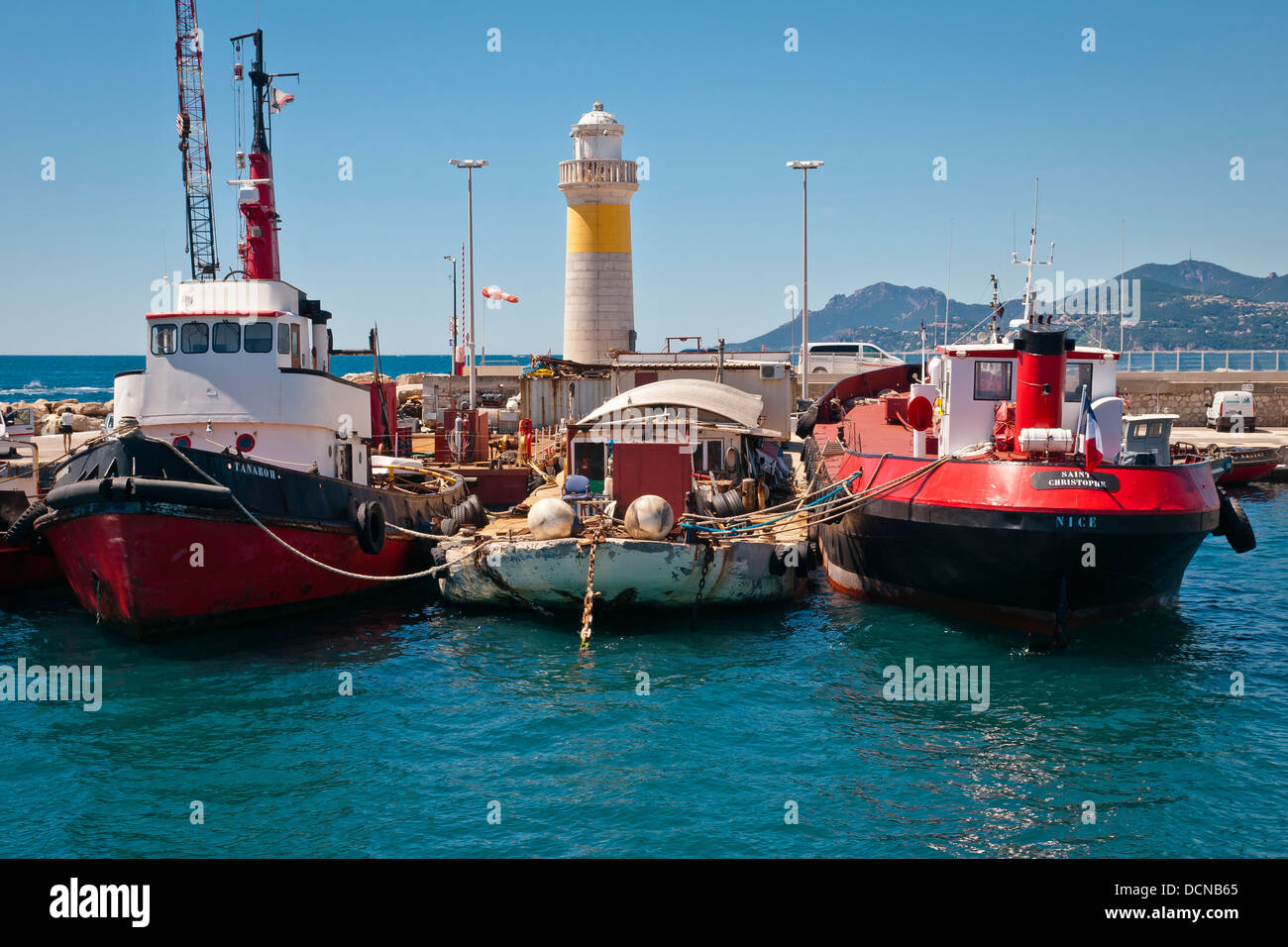 View pier with boats and a beacon of Cannes, French Riviera, France ...