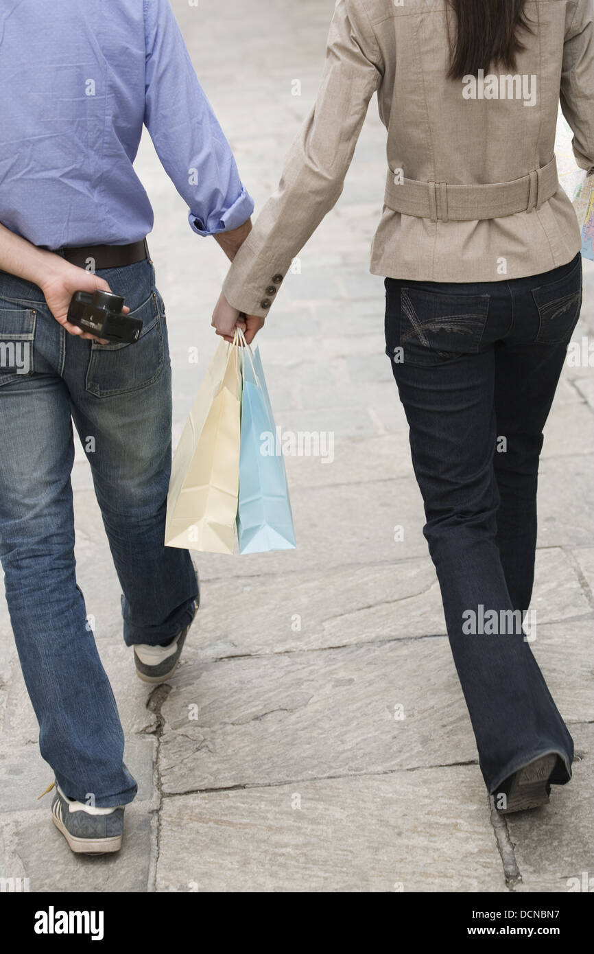 Back side of couple with shopping bags Stock Photo - Alamy