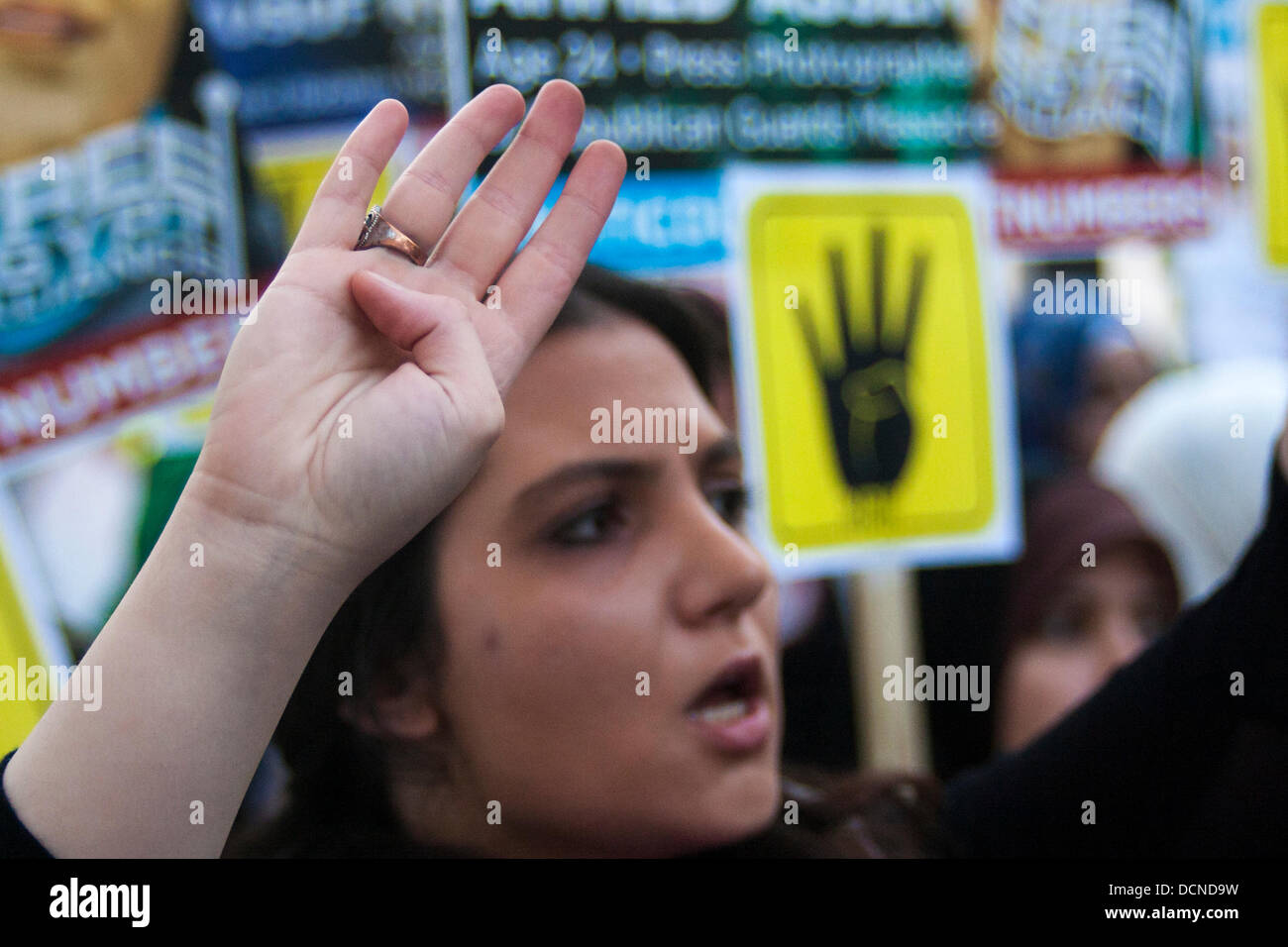 London, 20-08-2013. A woman's "Rabia" sign is replicated by a poster in ...