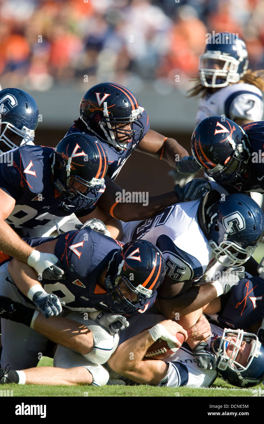 Connecticut quarterback Tyler Lorenzen(4) is sacked by Virginia NT ...