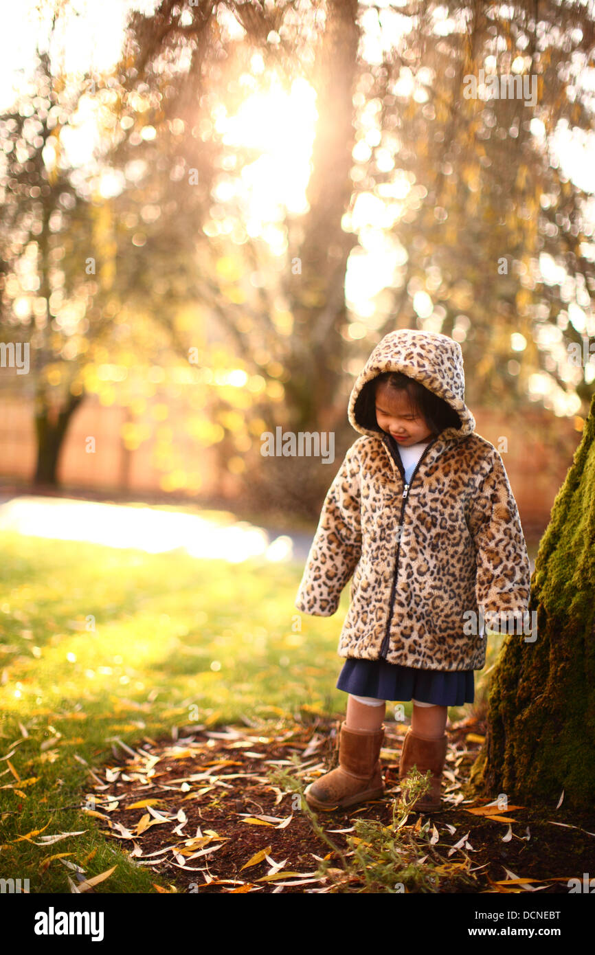 Young girl by trees in Fall Stock Photo - Alamy