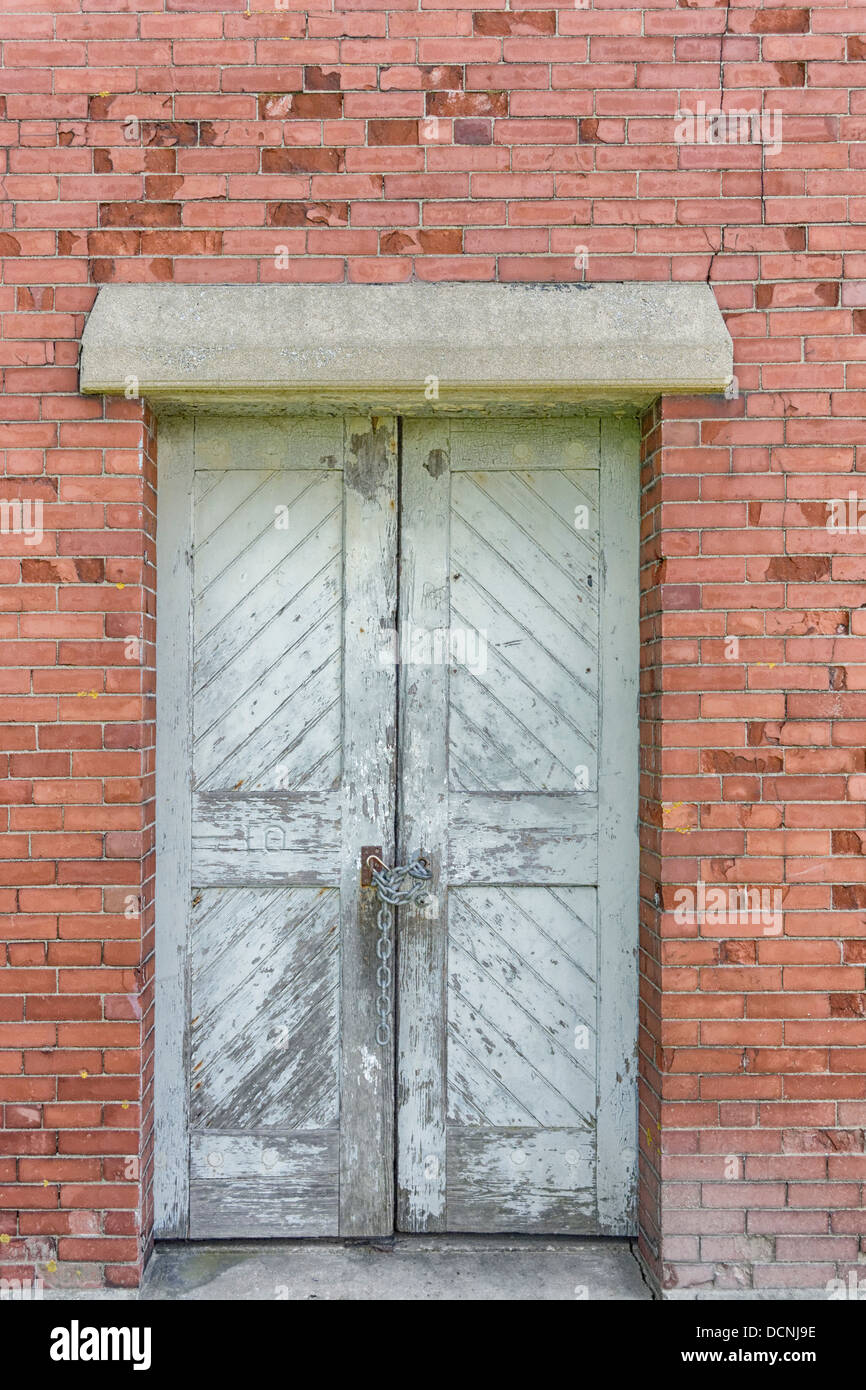 Weathered wooden doors held shut by chain at Fort Warren Stock Photo ...