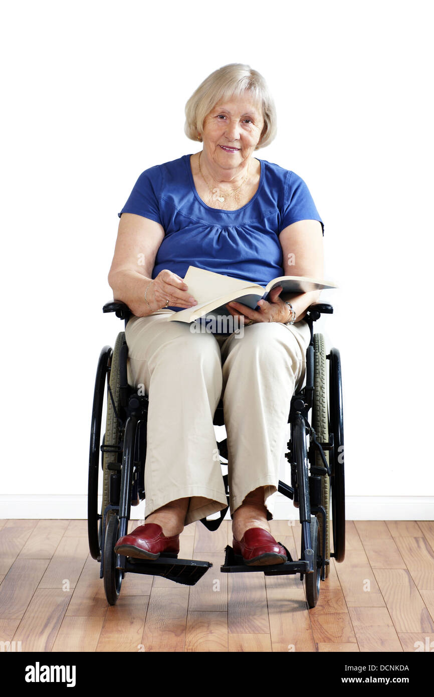 Senior disabled woman in wheelchair with book Stock Photo - Alamy
