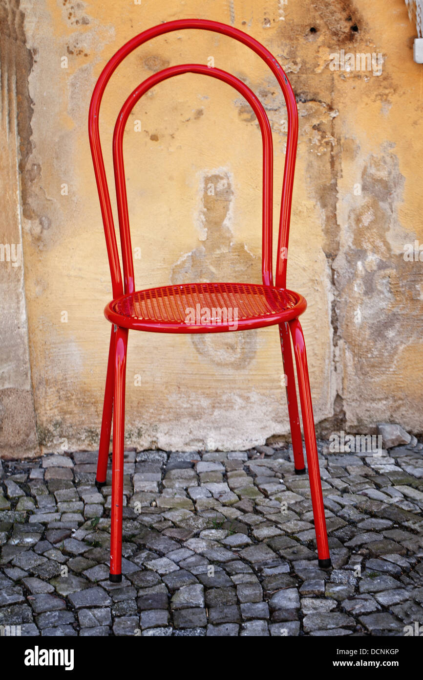 Old red Chair, on wall background Stock Photo - Alamy